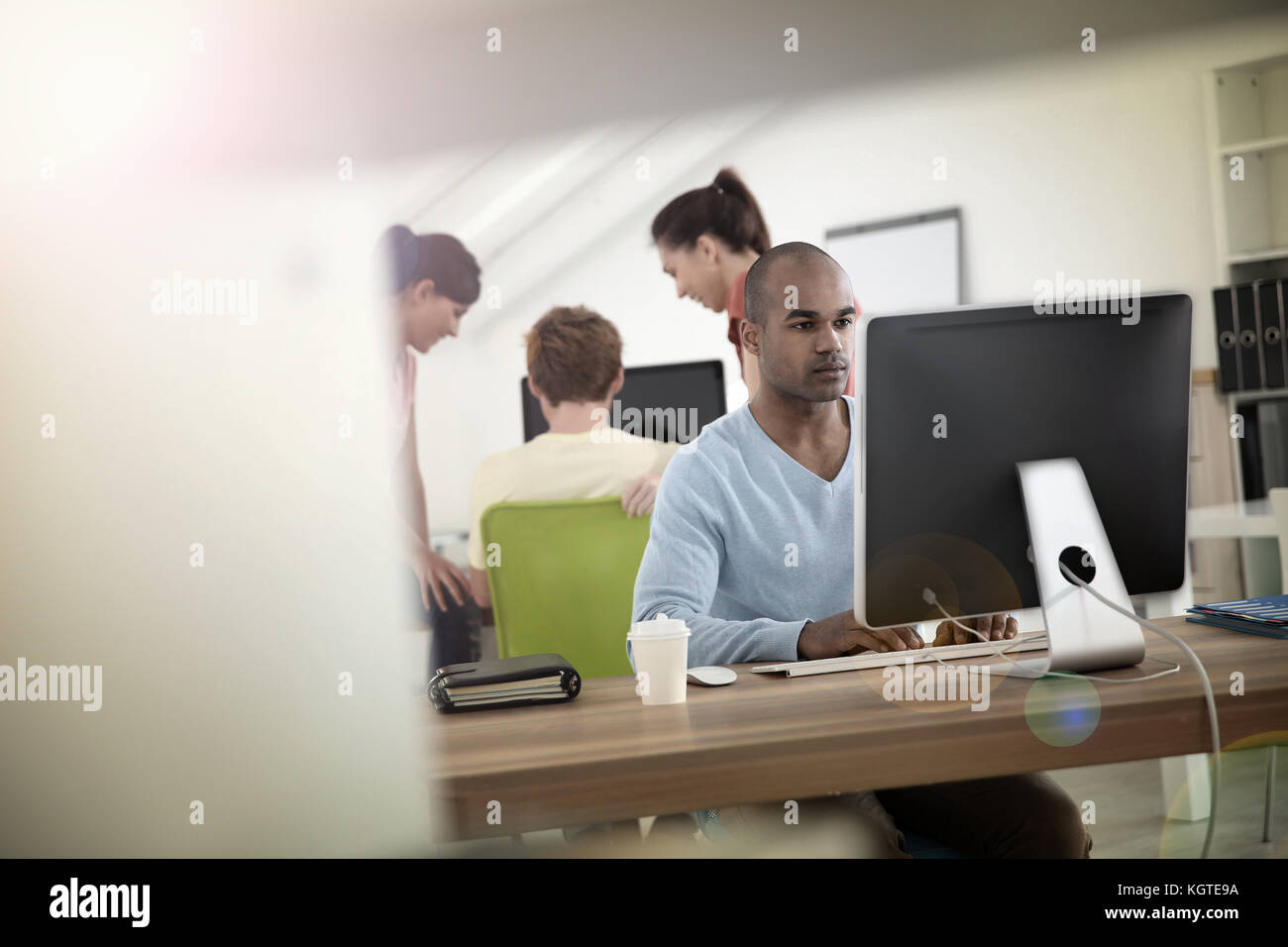 Man working on desktop computer Stock Photo - Alamy