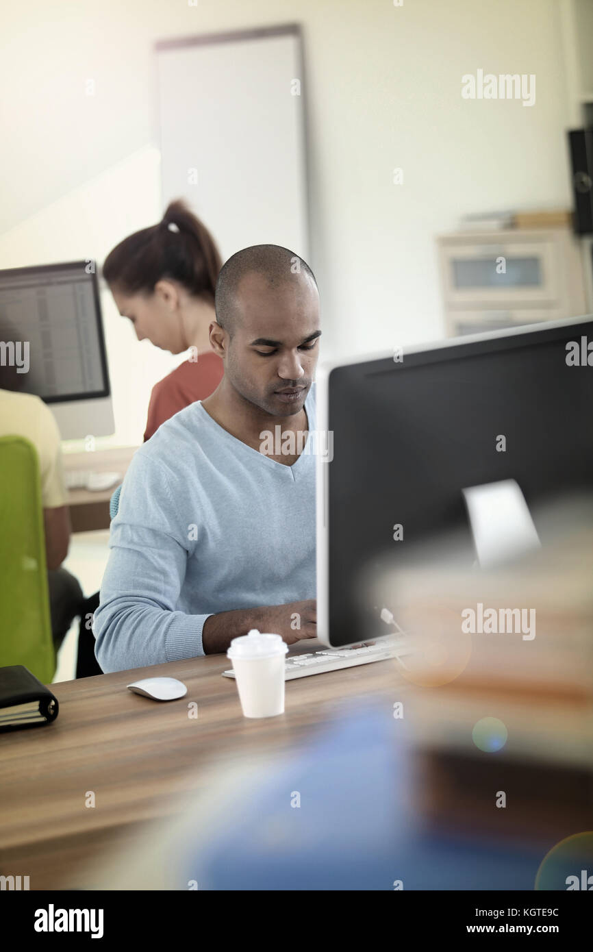 Man working on desktop computer Stock Photo - Alamy