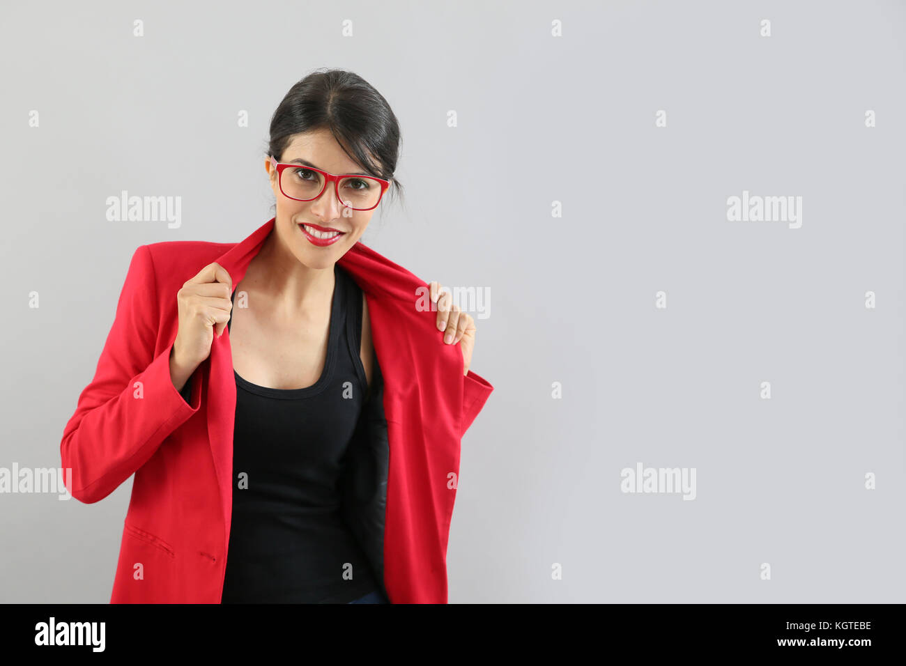 Beautiful brunette girl with red jacket, isolated Stock Photo - Alamy