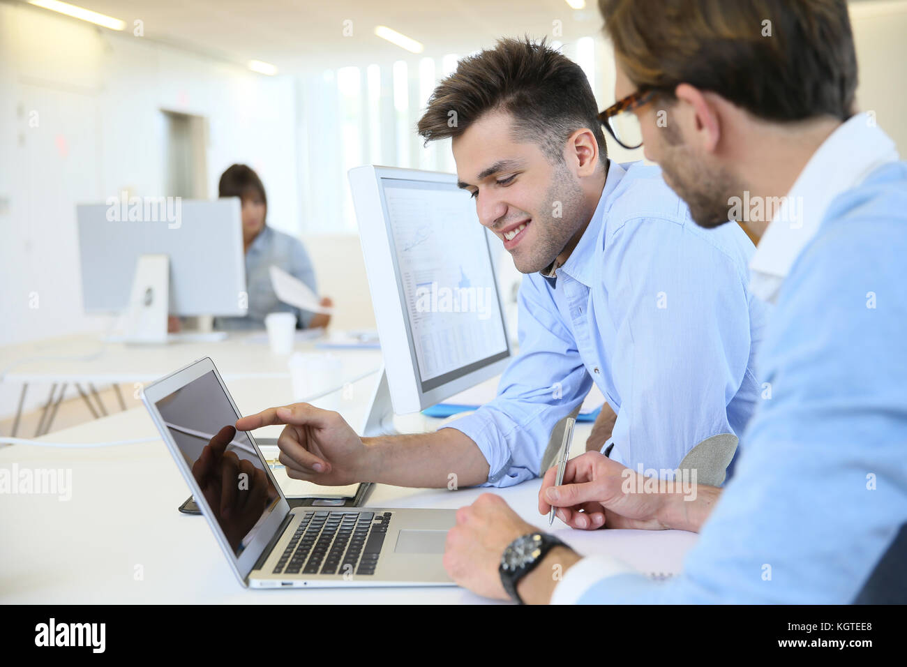 Businessmen in work meeting with laptop computer Stock Photo - Alamy