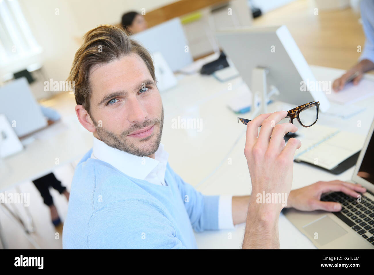 Businessman with eyeglasses working in office Stock Photo - Alamy