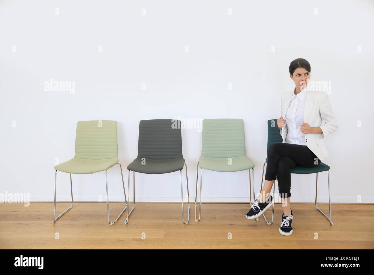 Woman in waiting room being serious Stock Photo - Alamy