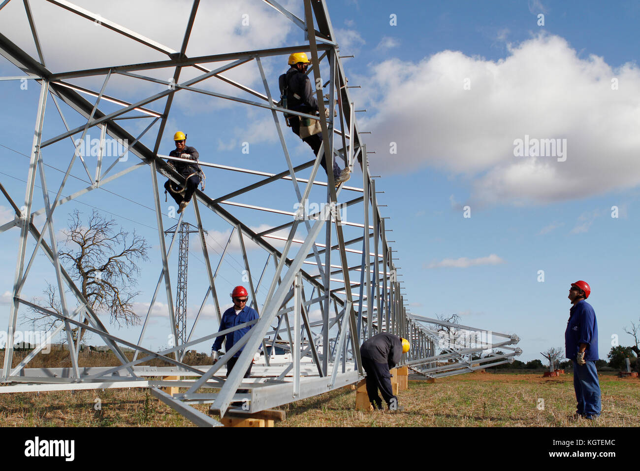 Workers install electrical high tension towers in Mallorca Stock Photo ...