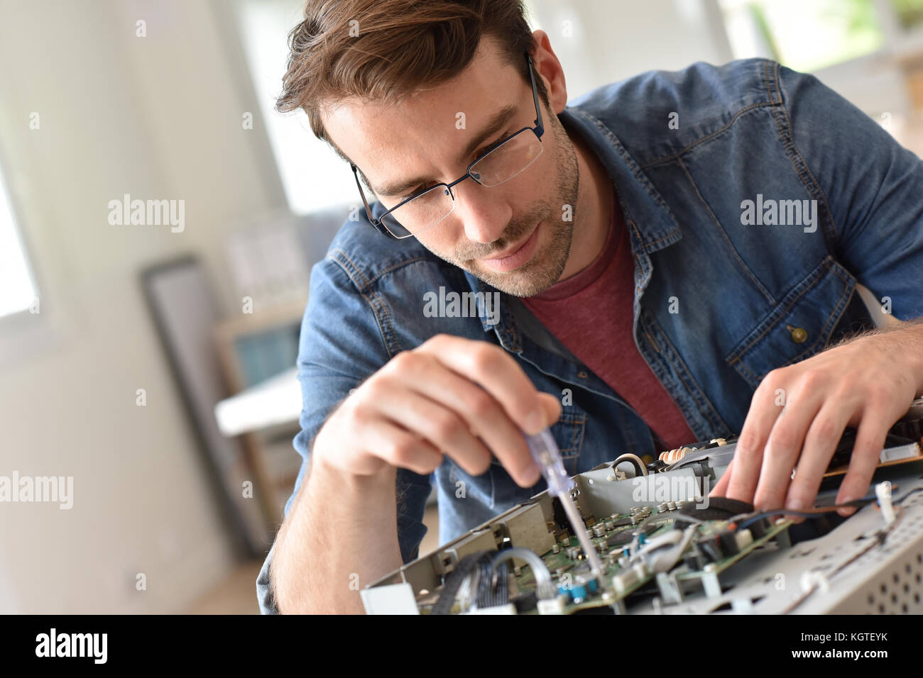 Repairman fixing tv set Stock Photo - Alamy