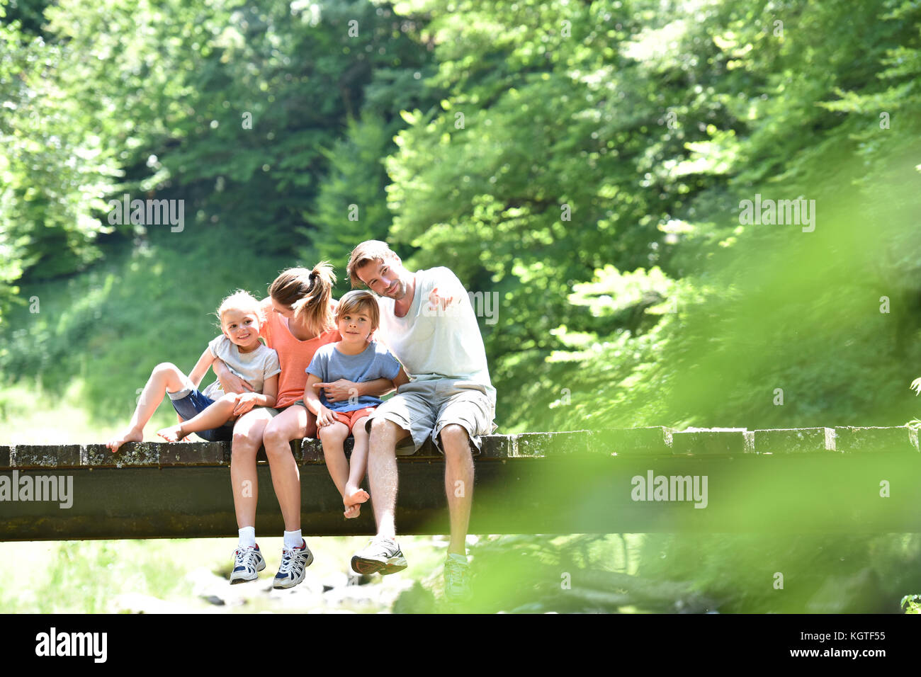 Boy girl sitting on bridge hi-res stock photography and images - Alamy