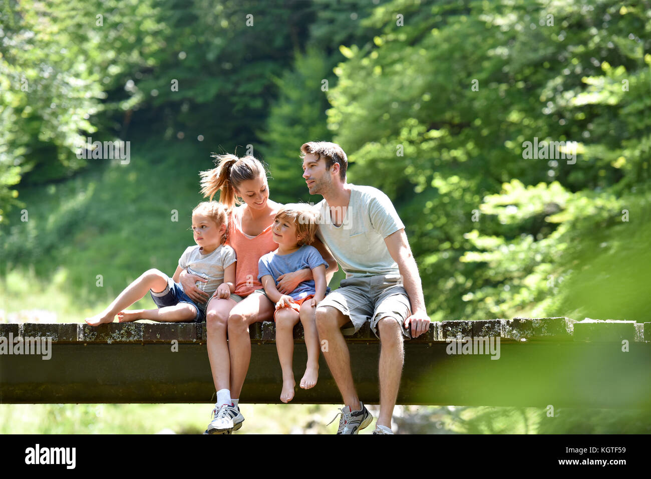 Boy girl sitting on bridge hi-res stock photography and images - Alamy