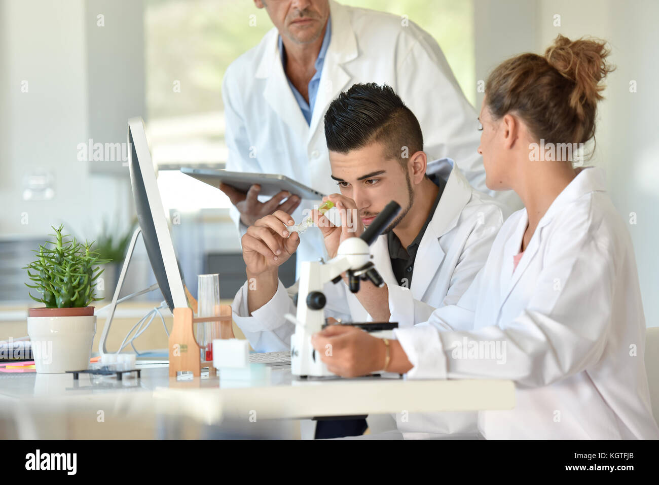 Students in biology attending training with microbiologist Stock Photo ...