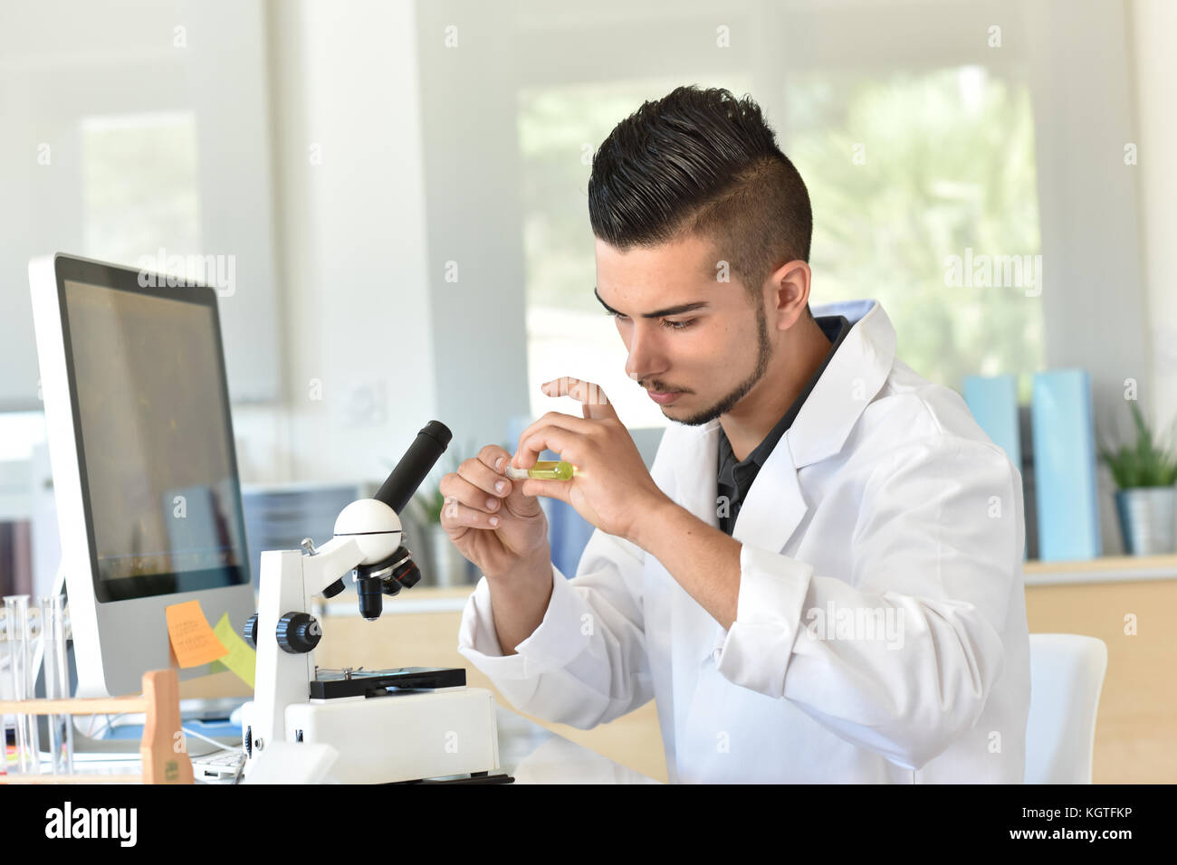 Student in biology using microscope in training class Stock Photo - Alamy