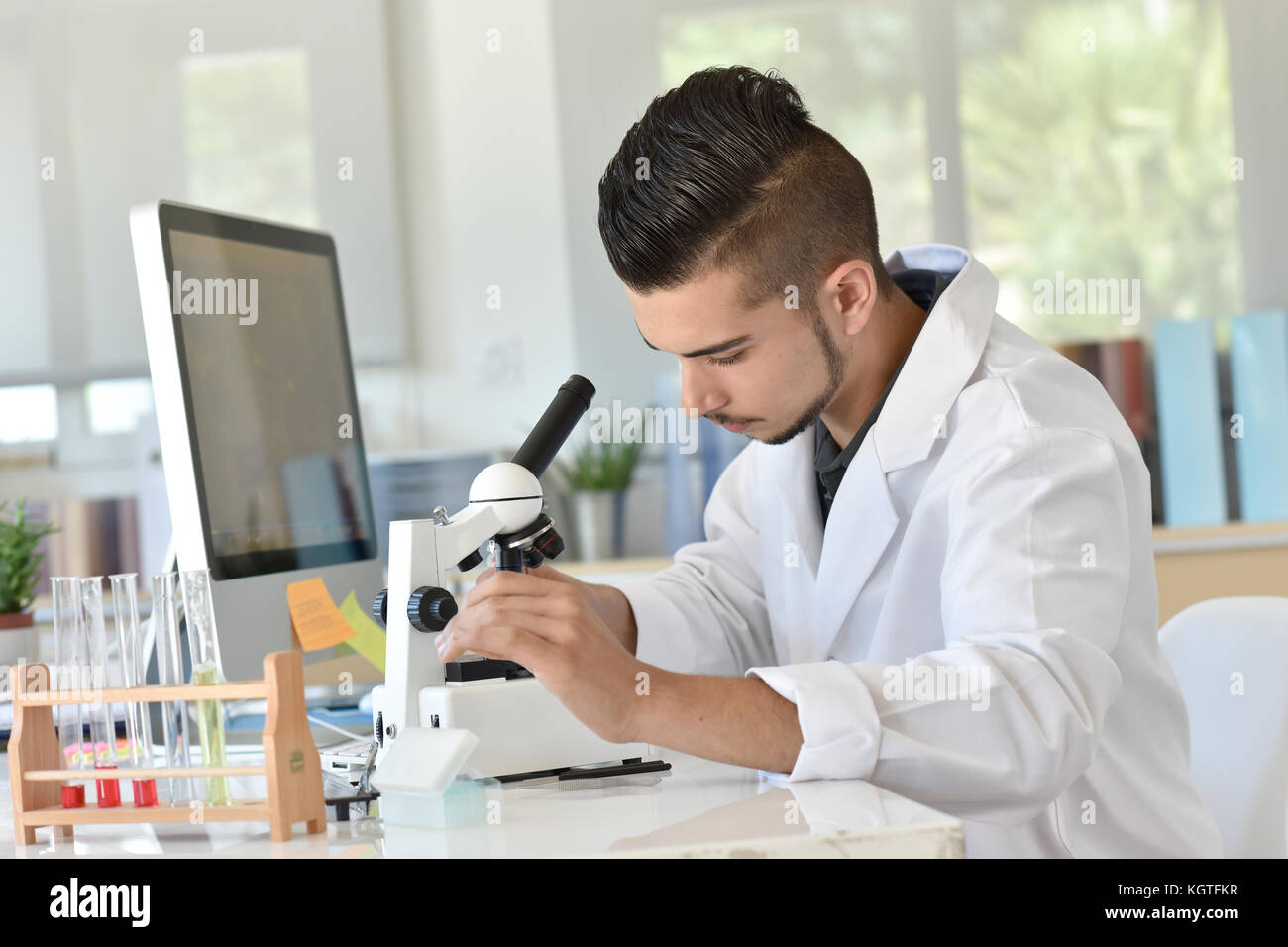 Student in biology using microscope in training class Stock Photo - Alamy