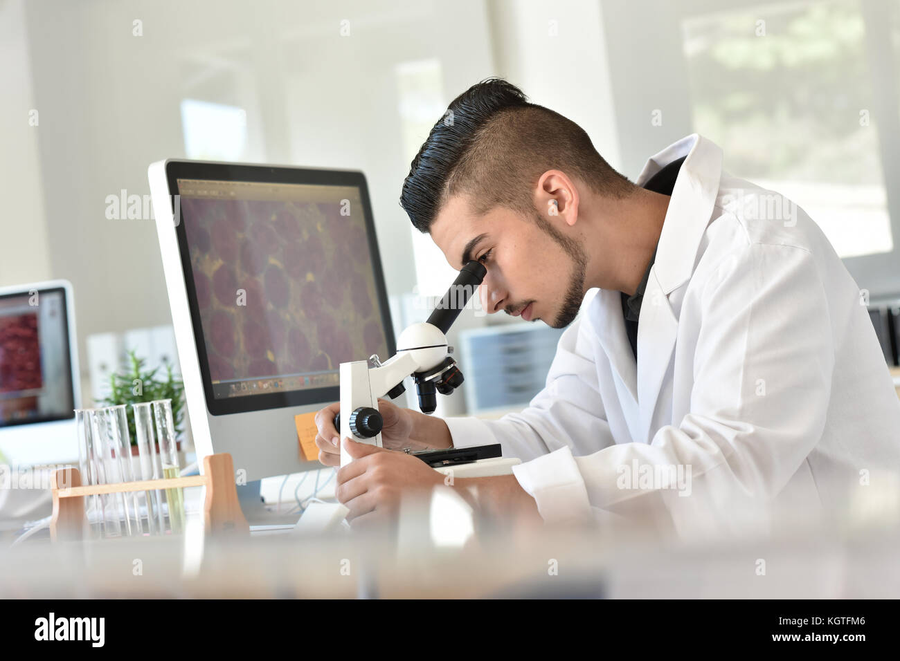 Student in biology using microscope in training class Stock Photo - Alamy