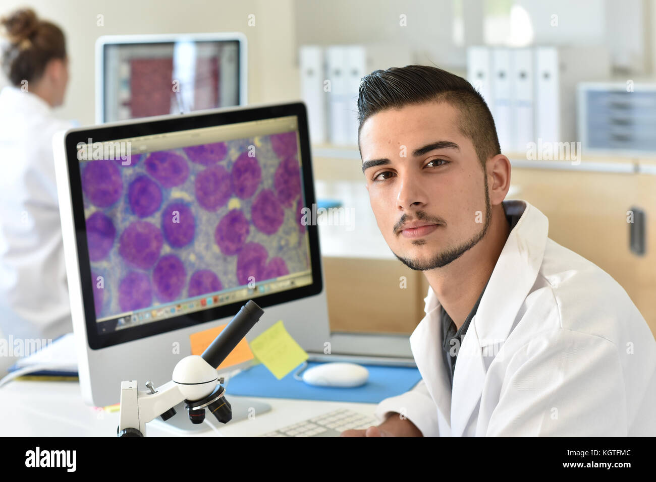 Student in biology using microscope in training class Stock Photo - Alamy