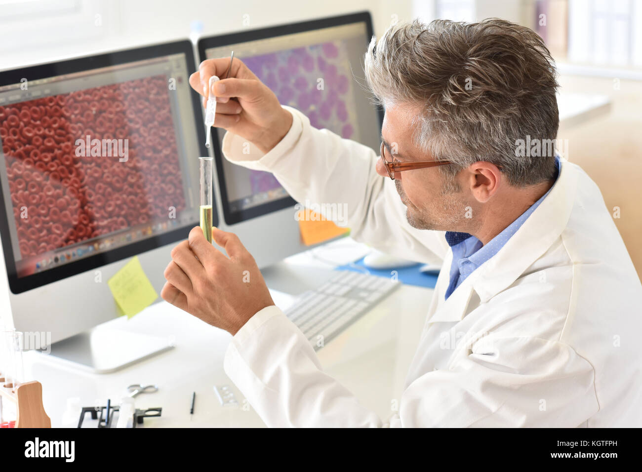 Microbiologist working on microscope in hi-res stock photography and ...