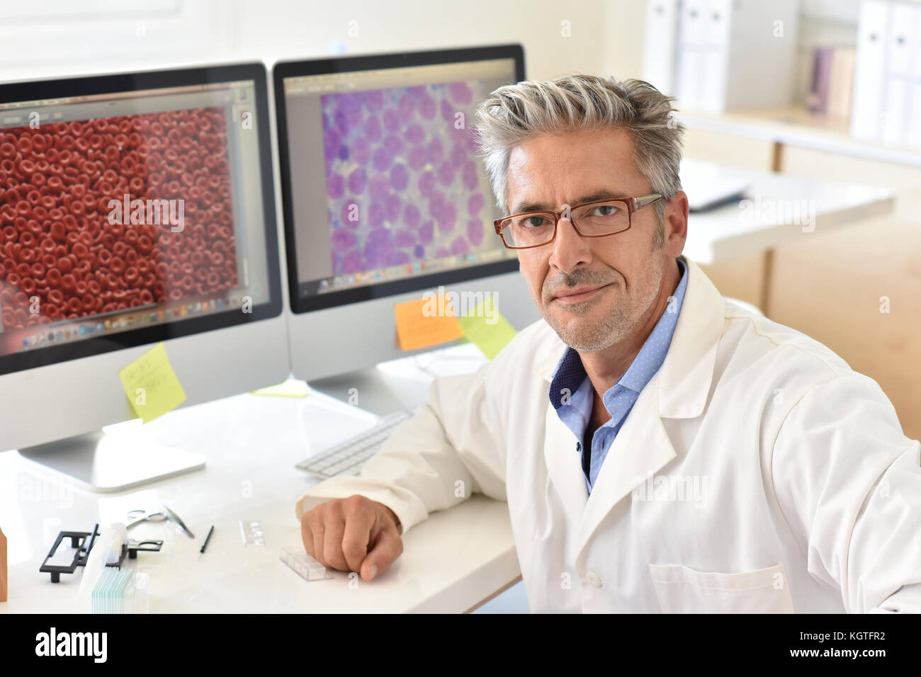Portrait of microbiology scientist in office Stock Photo - Alamy