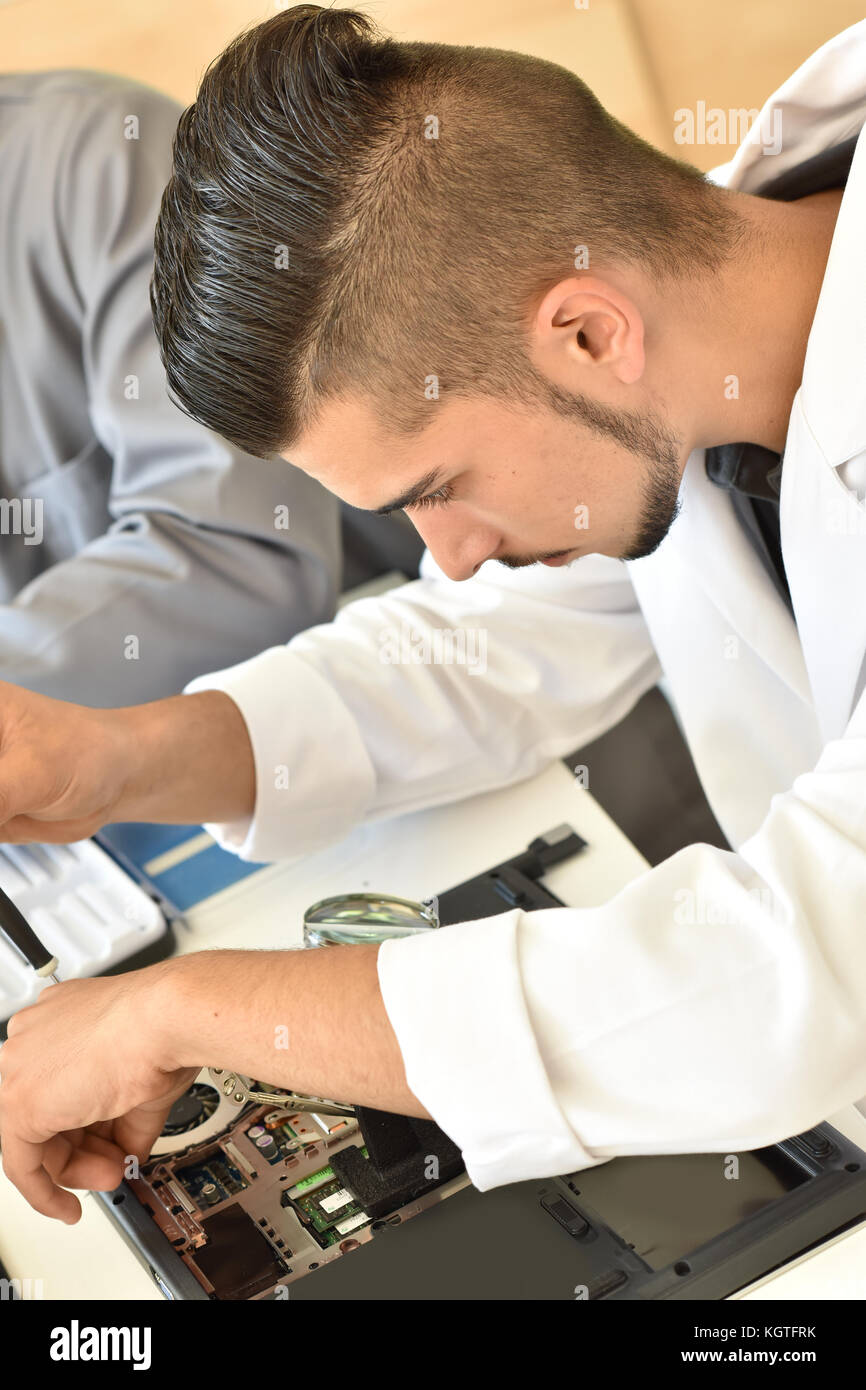 Student in technology fixing computer processing Stock Photo - Alamy
