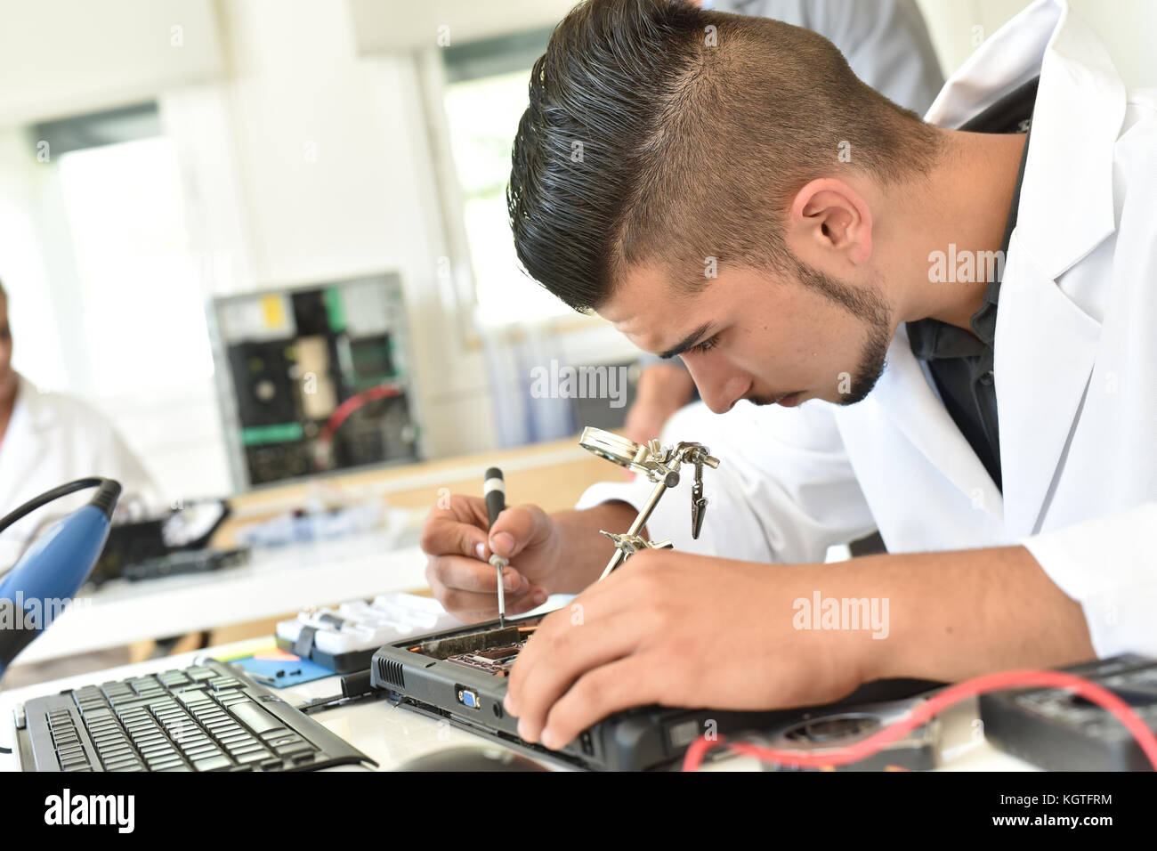Student in technology fixing computer processing Stock Photo - Alamy