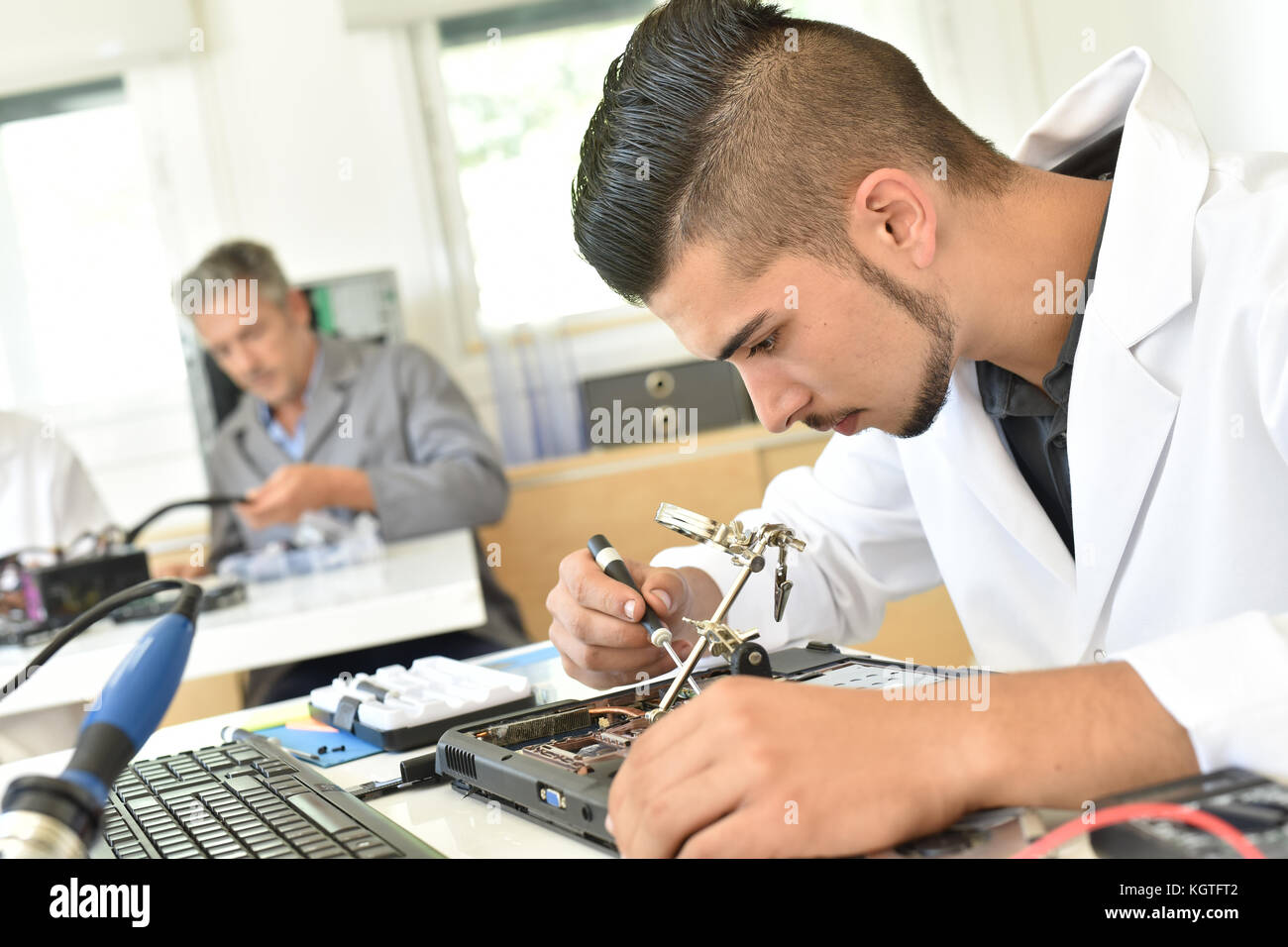 Student in technology fixing computer processing Stock Photo - Alamy