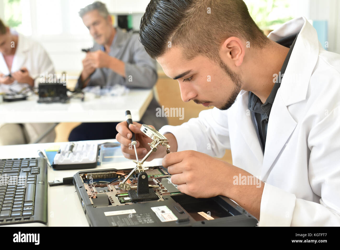 Student in technology fixing computer processing Stock Photo - Alamy