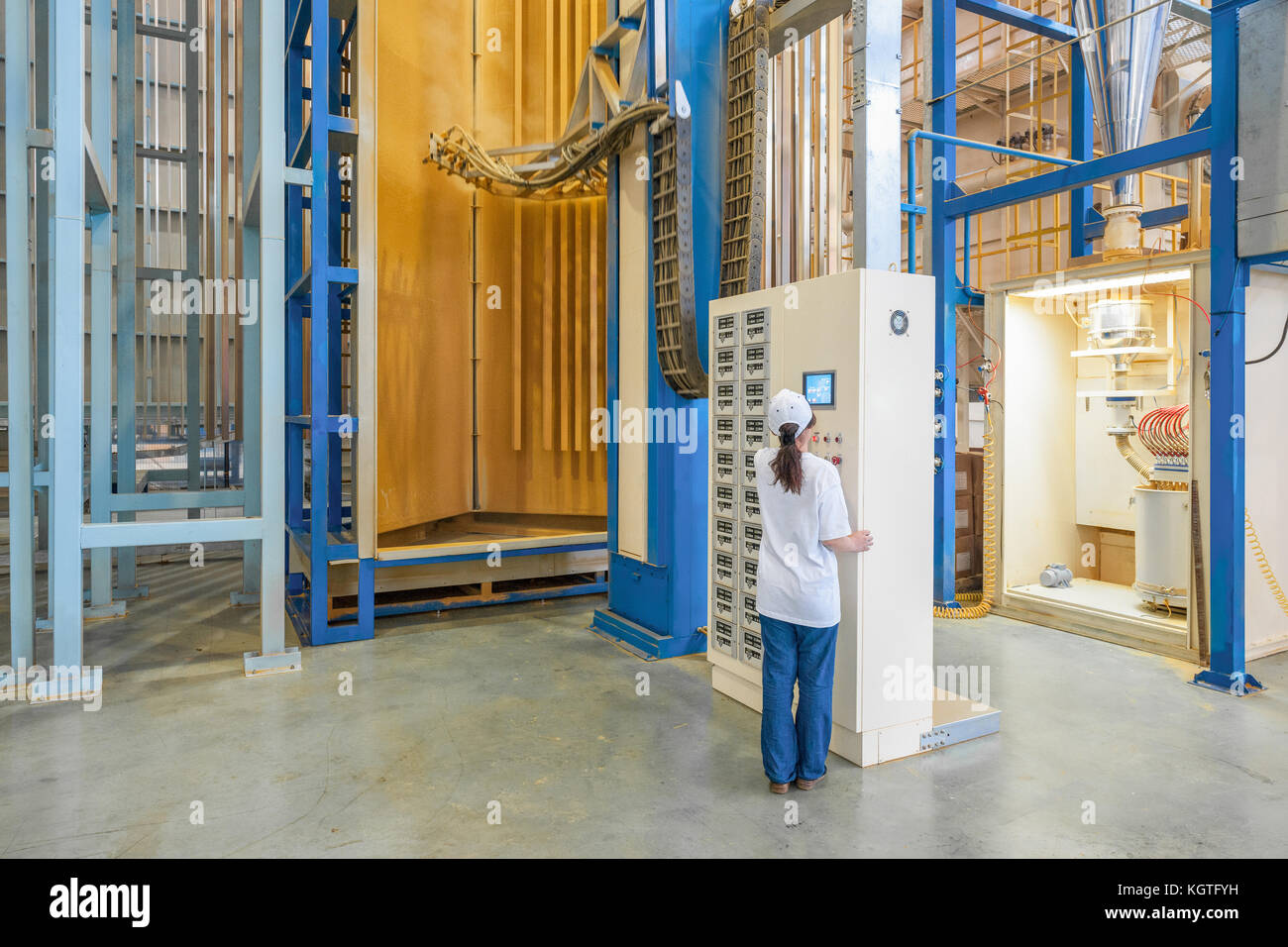 powder coating system. woman operator behind the dashboard in the shop ...