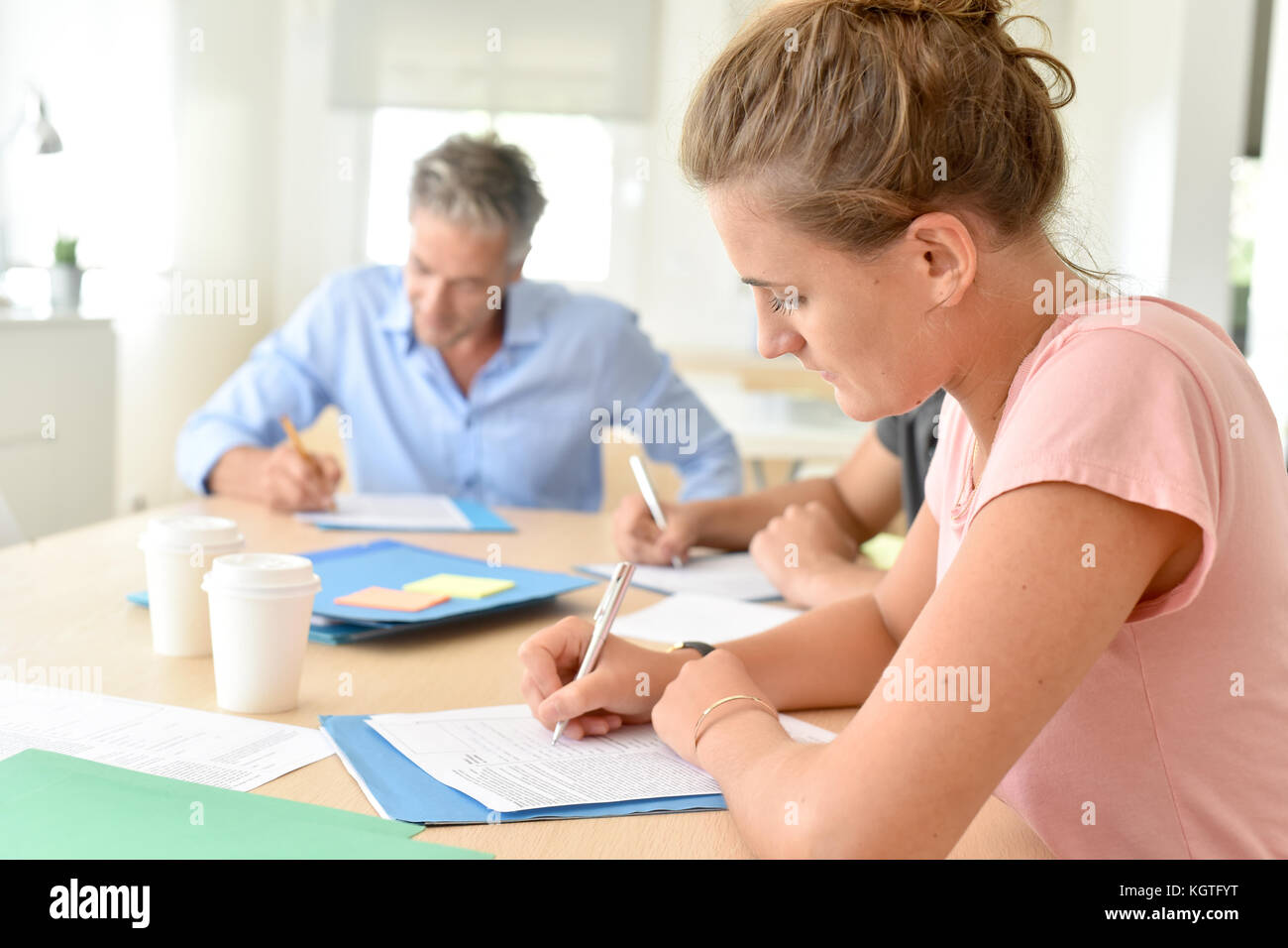 College students filling in registration forms Stock Photo - Alamy