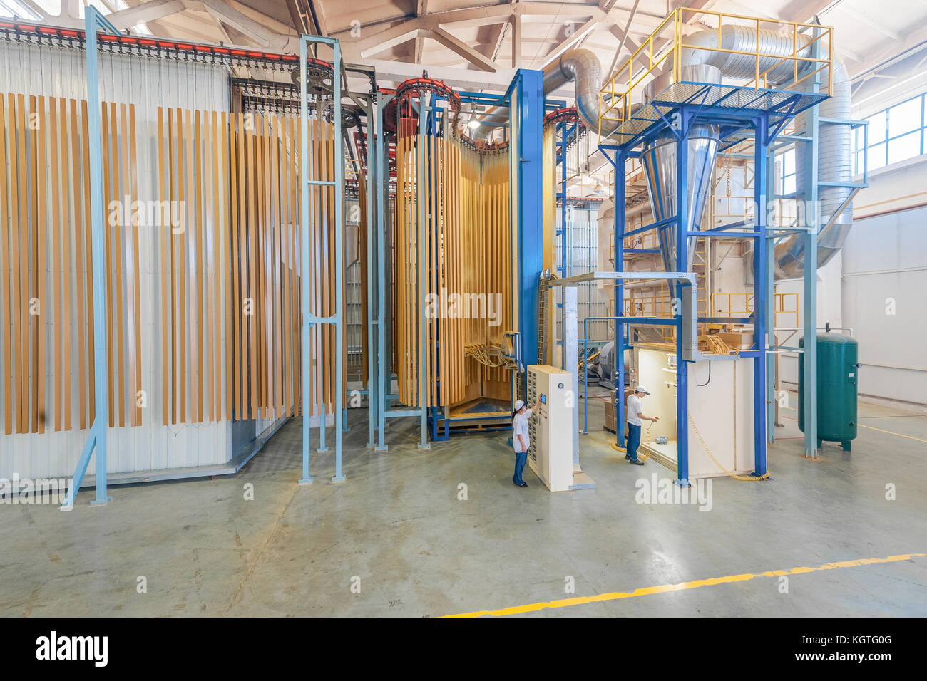 powder coating system. woman operator behind the dashboard in the shop ...