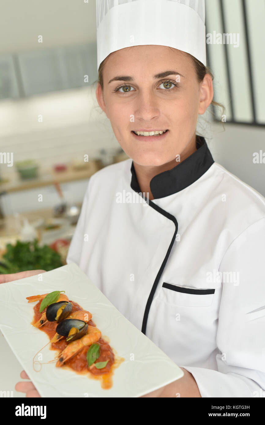 Young chef in cooking training school presenting dish Stock Photo - Alamy