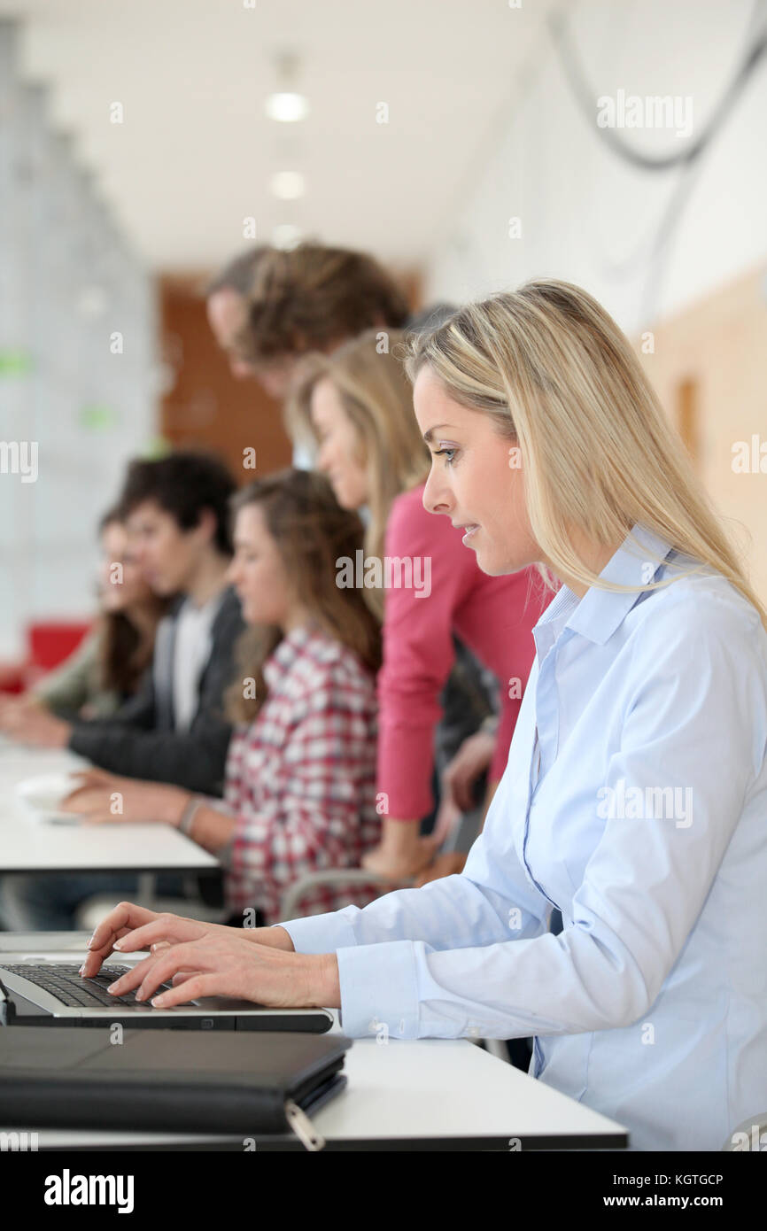 teacher working on laptop computer in classroom Stock Photo - Alamy