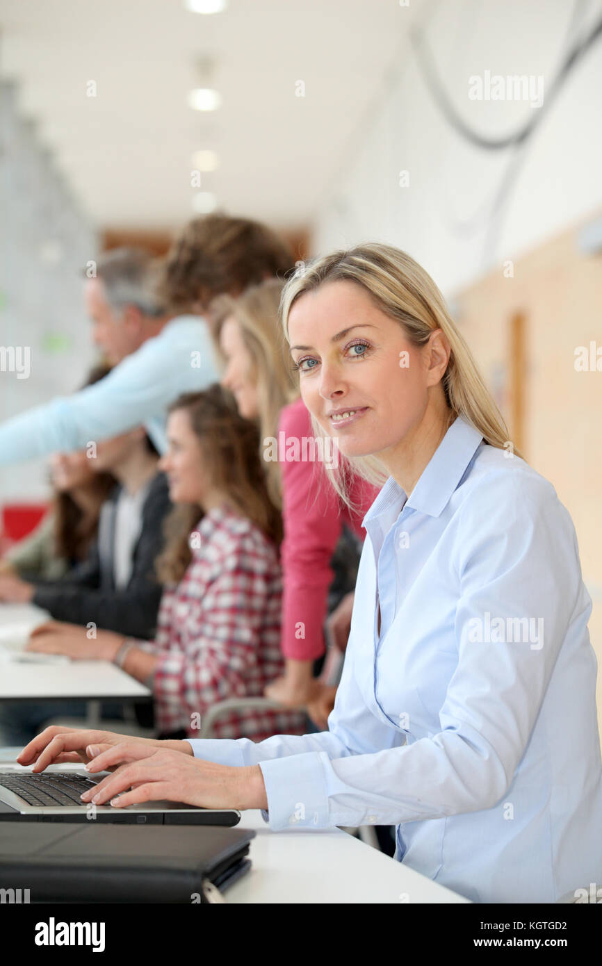 teacher working on laptop computer in classroom Stock Photo - Alamy