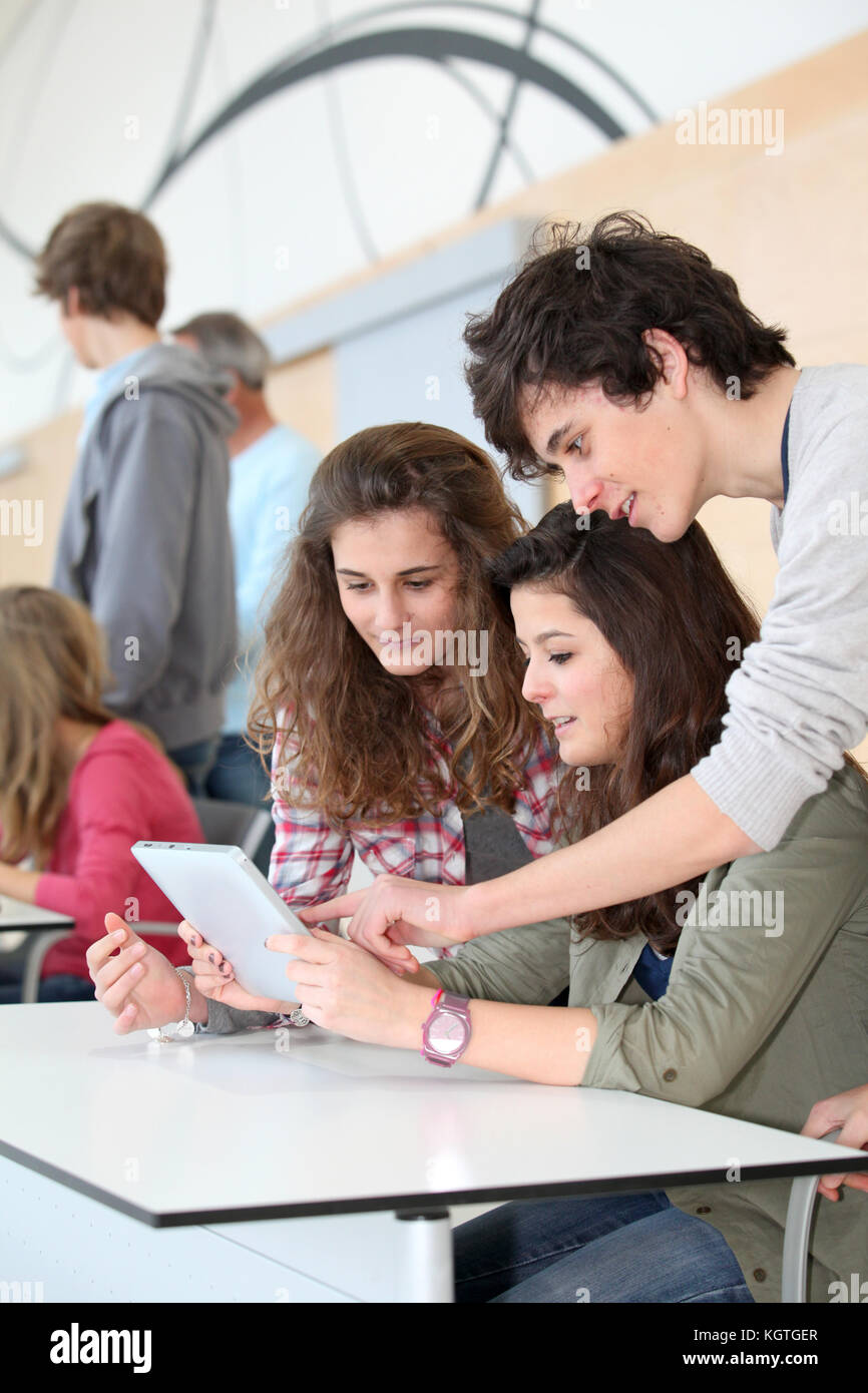 Group of teenagers in classroom with electronic tablet Stock Photo - Alamy