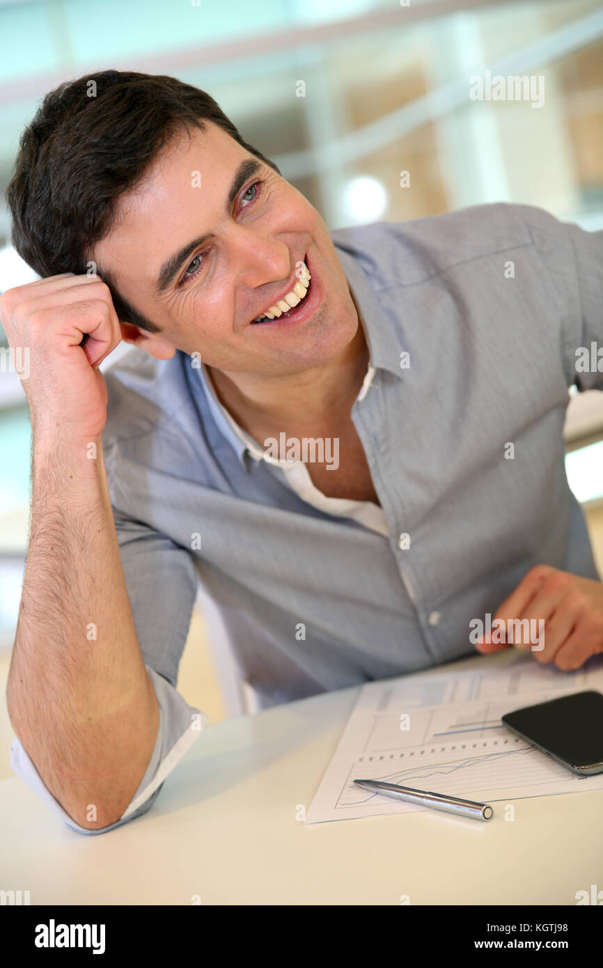 Man at work in office joking with colleague Stock Photo - Alamy