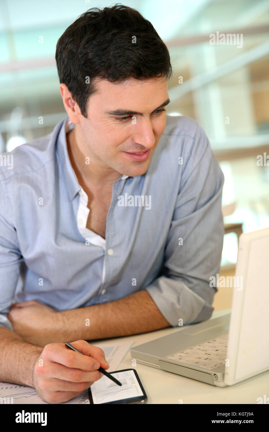 Businessman at work using smartphone Stock Photo - Alamy