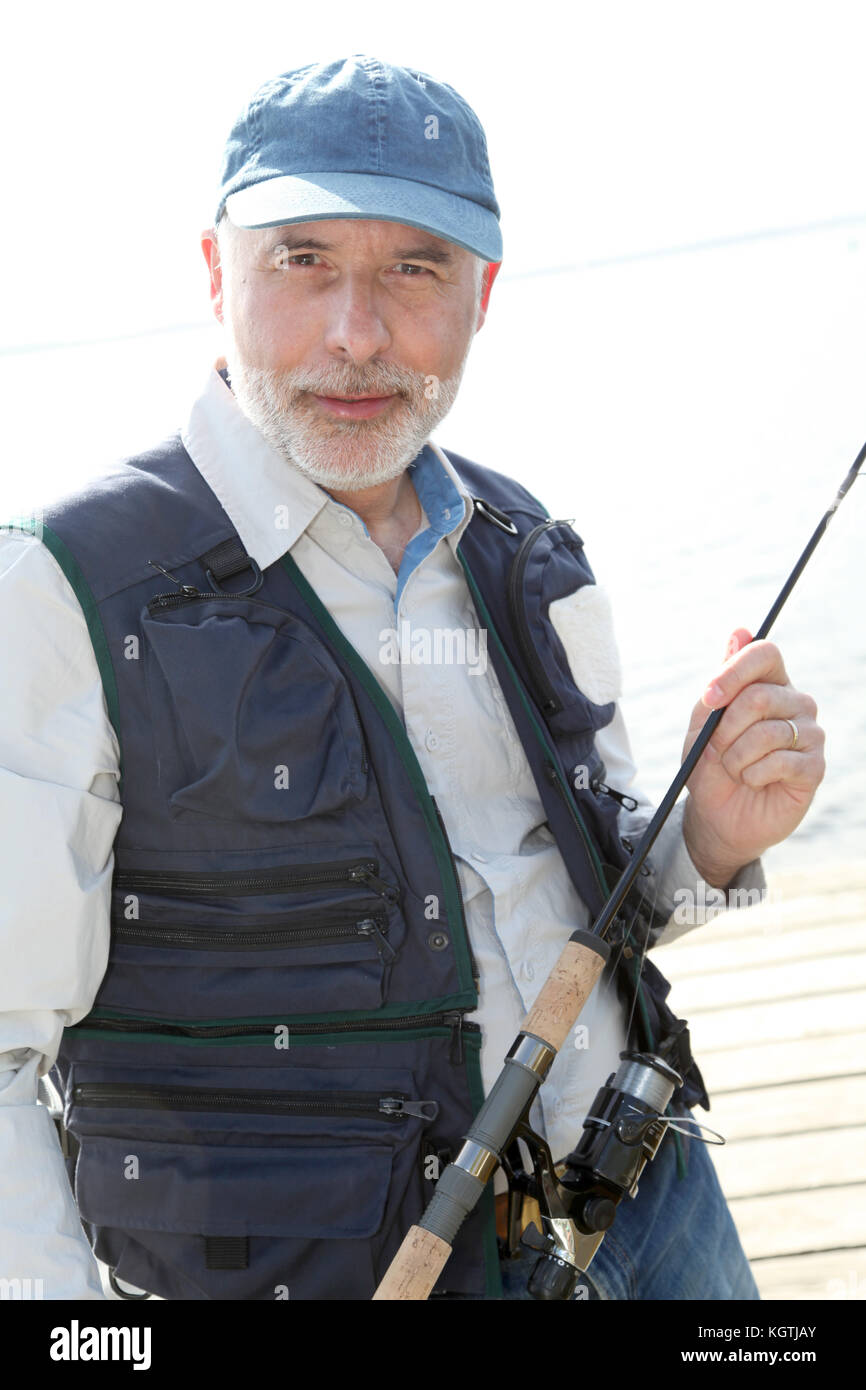 Portrait of smiling senior fisherman Stock Photo - Alamy