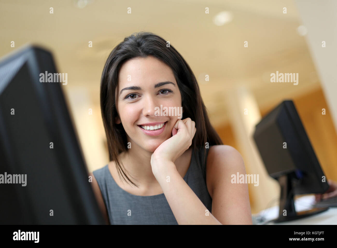 Smiling office worker at ther desk Stock Photo - Alamy