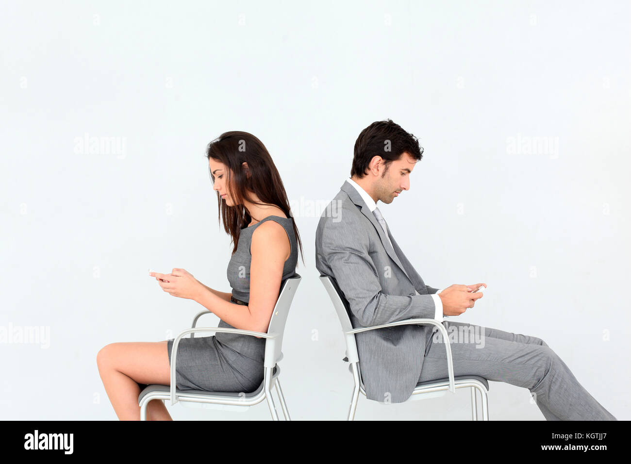 Business people sitting in chairs with mobile phone Stock Photo - Alamy
