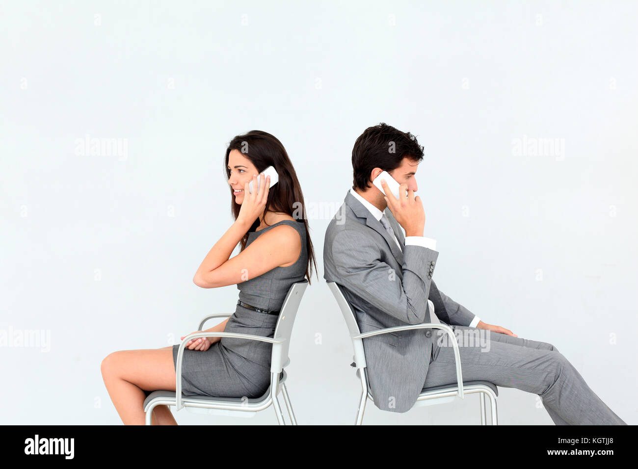Business people sitting in chairs with mobile phone Stock Photo - Alamy