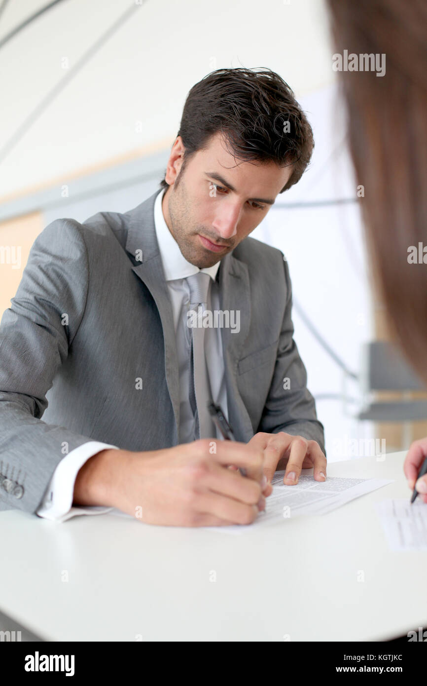 Businessman filling in business contract Stock Photo - Alamy