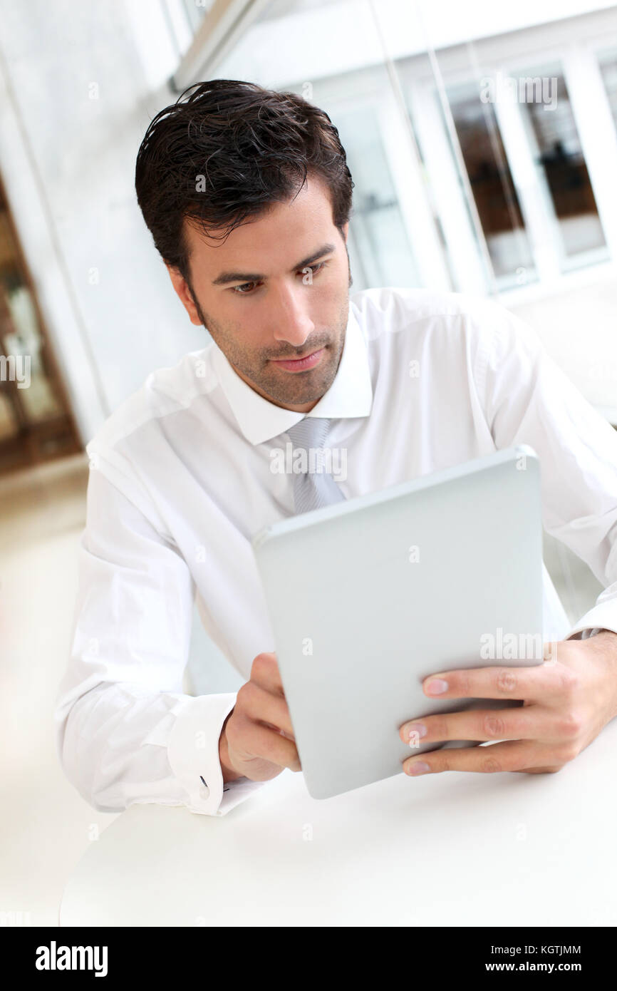 Businessman working on electronic tablet Stock Photo - Alamy