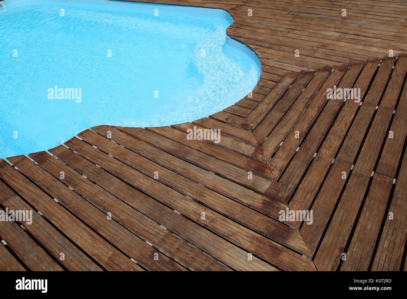 Closeup of swimming pool with wooden floor around Stock Photo - Alamy