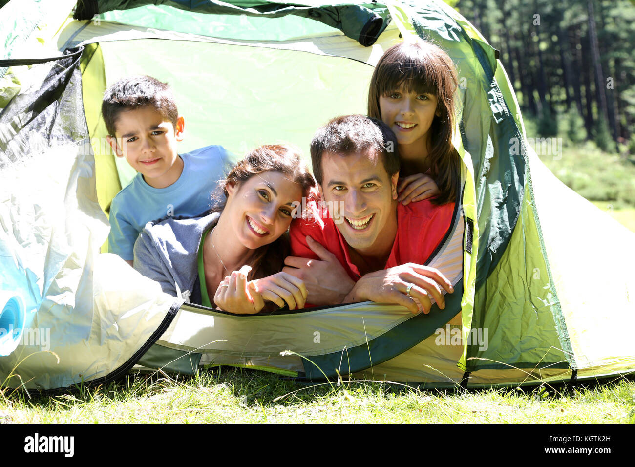 Portrait of family laying in camp tent Stock Photo - Alamy
