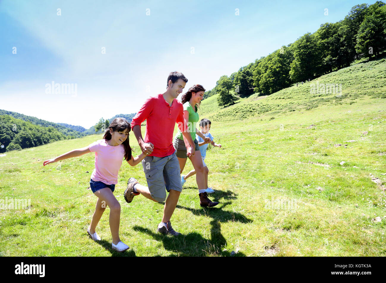 Four kids holding hands running hi-res stock photography and images - Alamy