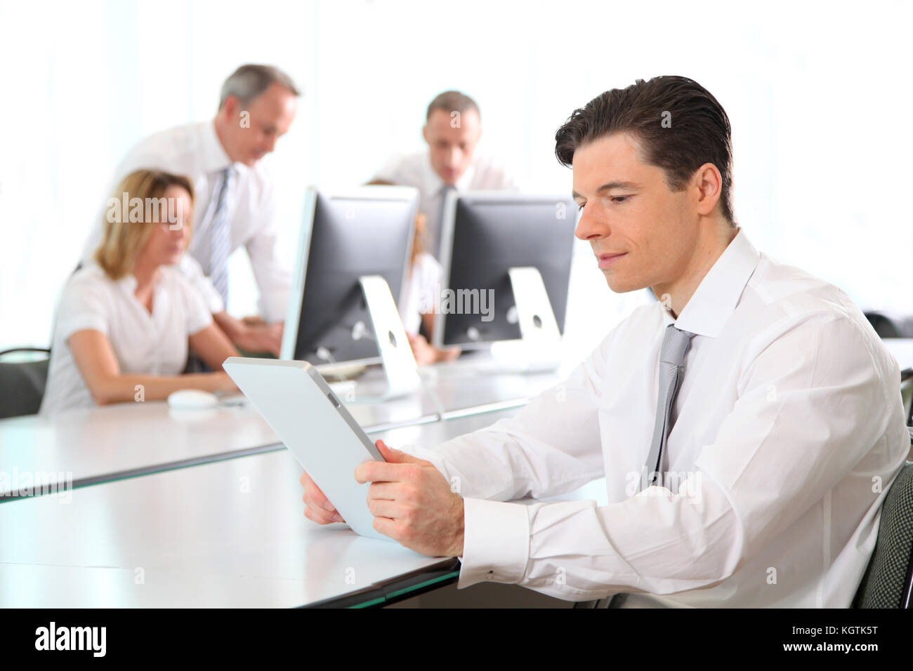 Office worker using electronic tablet in office Stock Photo - Alamy