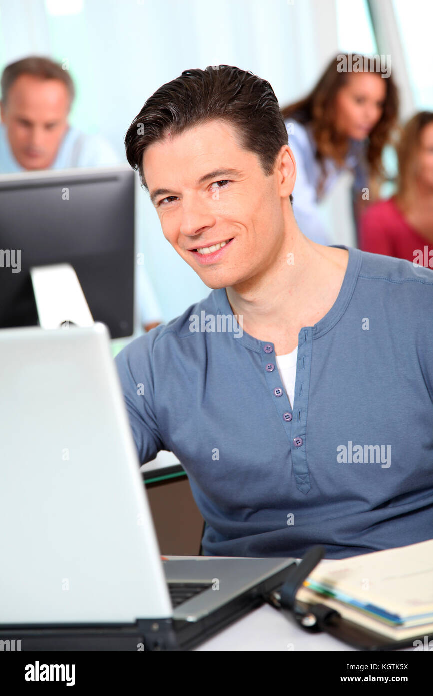 Portrait of office worker in front of laptop computer Stock Photo - Alamy