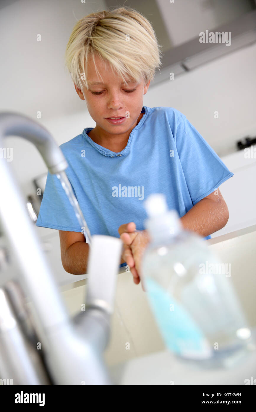 Young boy washing his hands Stock Photo - Alamy