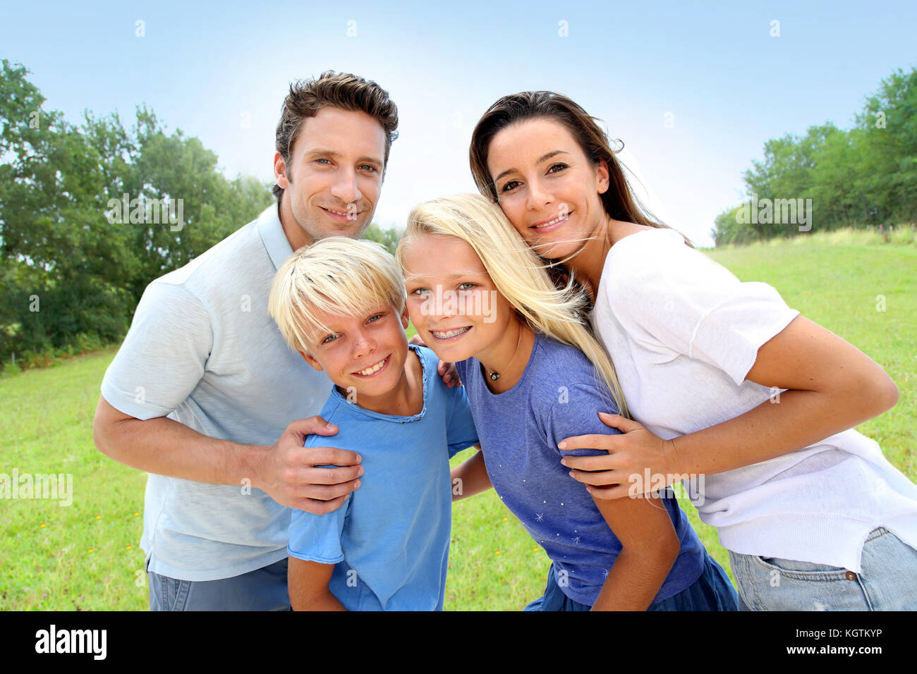 Portrait fo happy family standing in natural landscape Stock Photo - Alamy