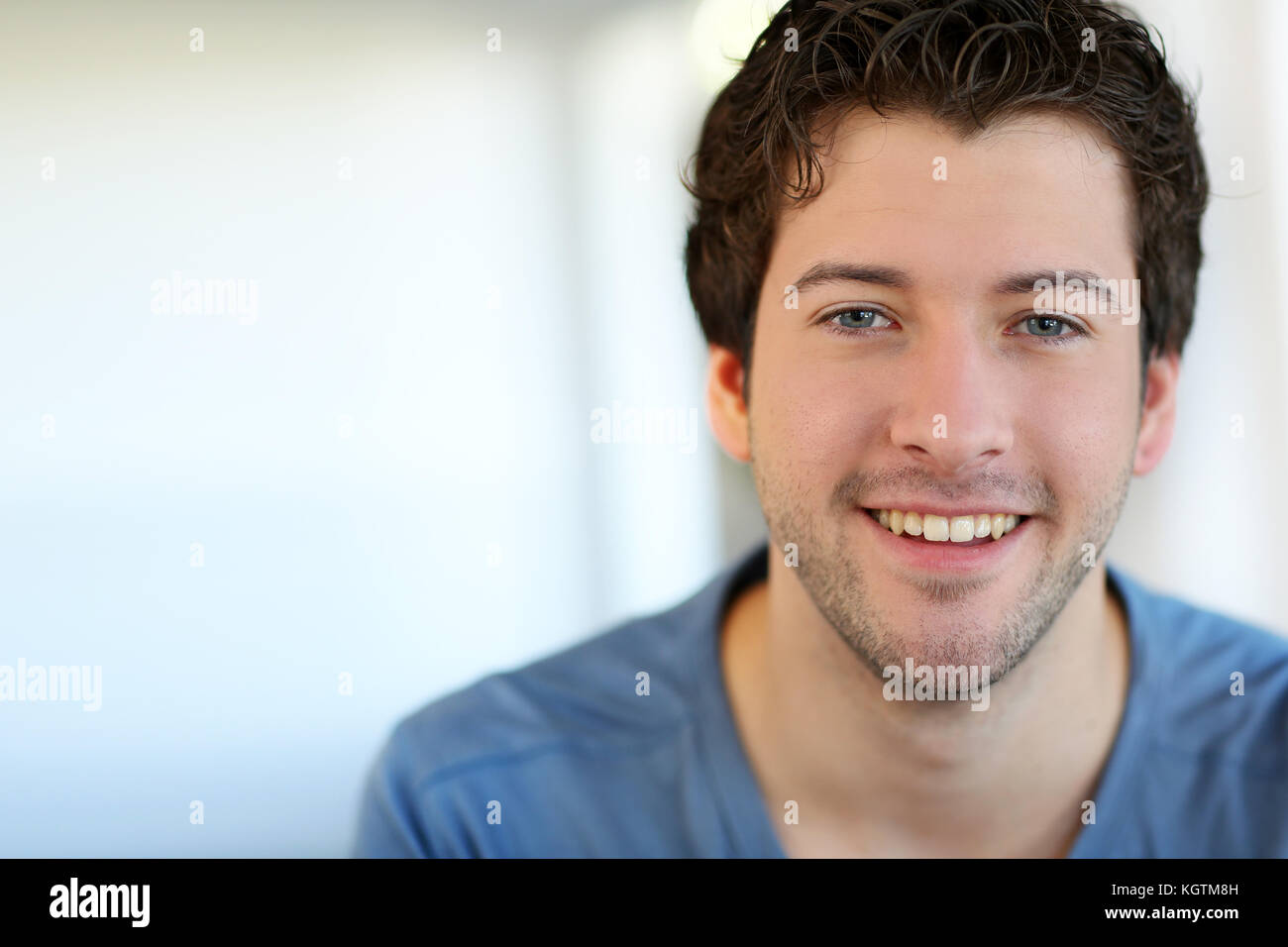 Portrait of cheerful young guy with blue eyes Stock Photo - Alamy