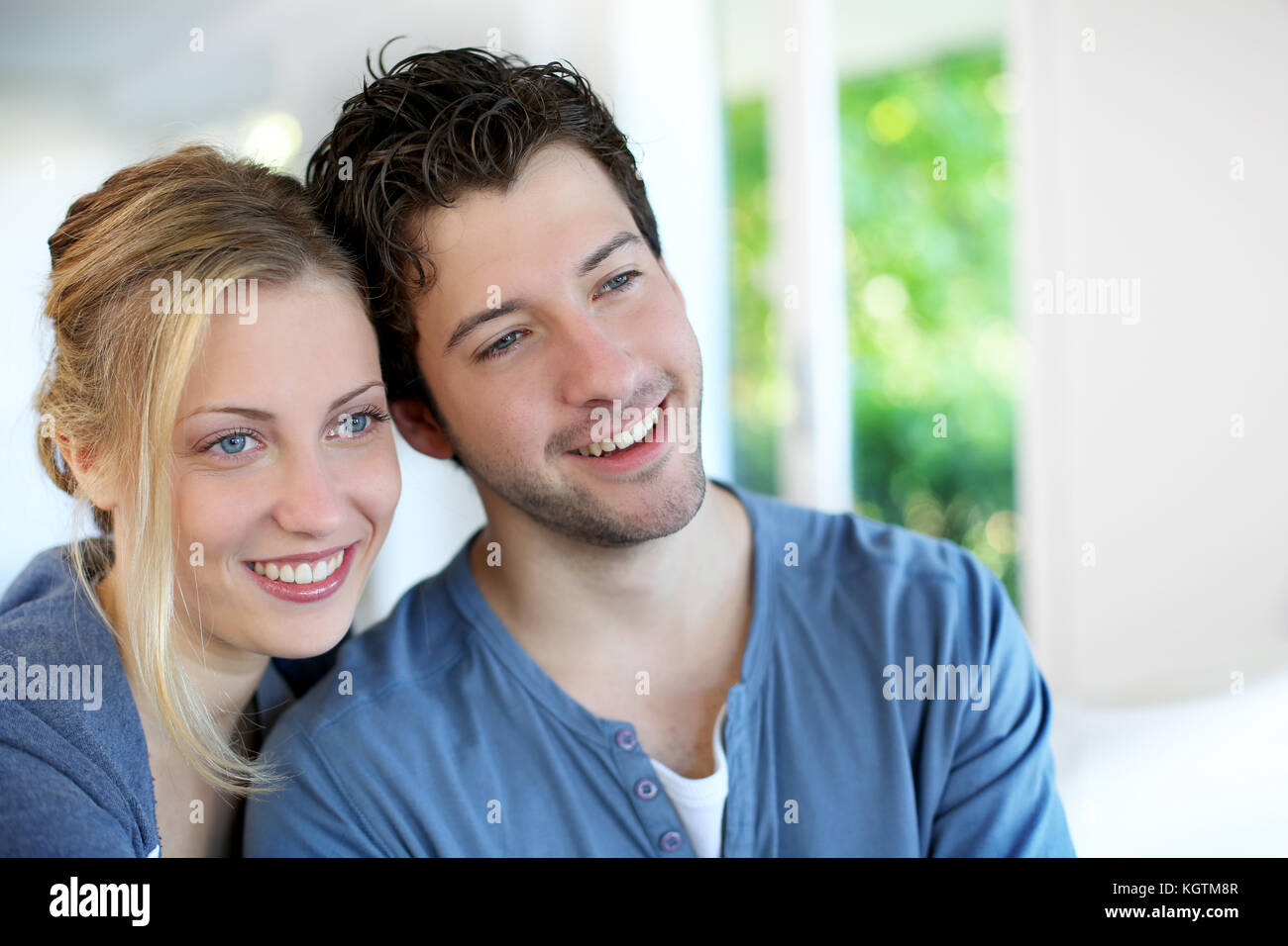 Closeup of cheerful young couple wearing blue Stock Photo - Alamy
