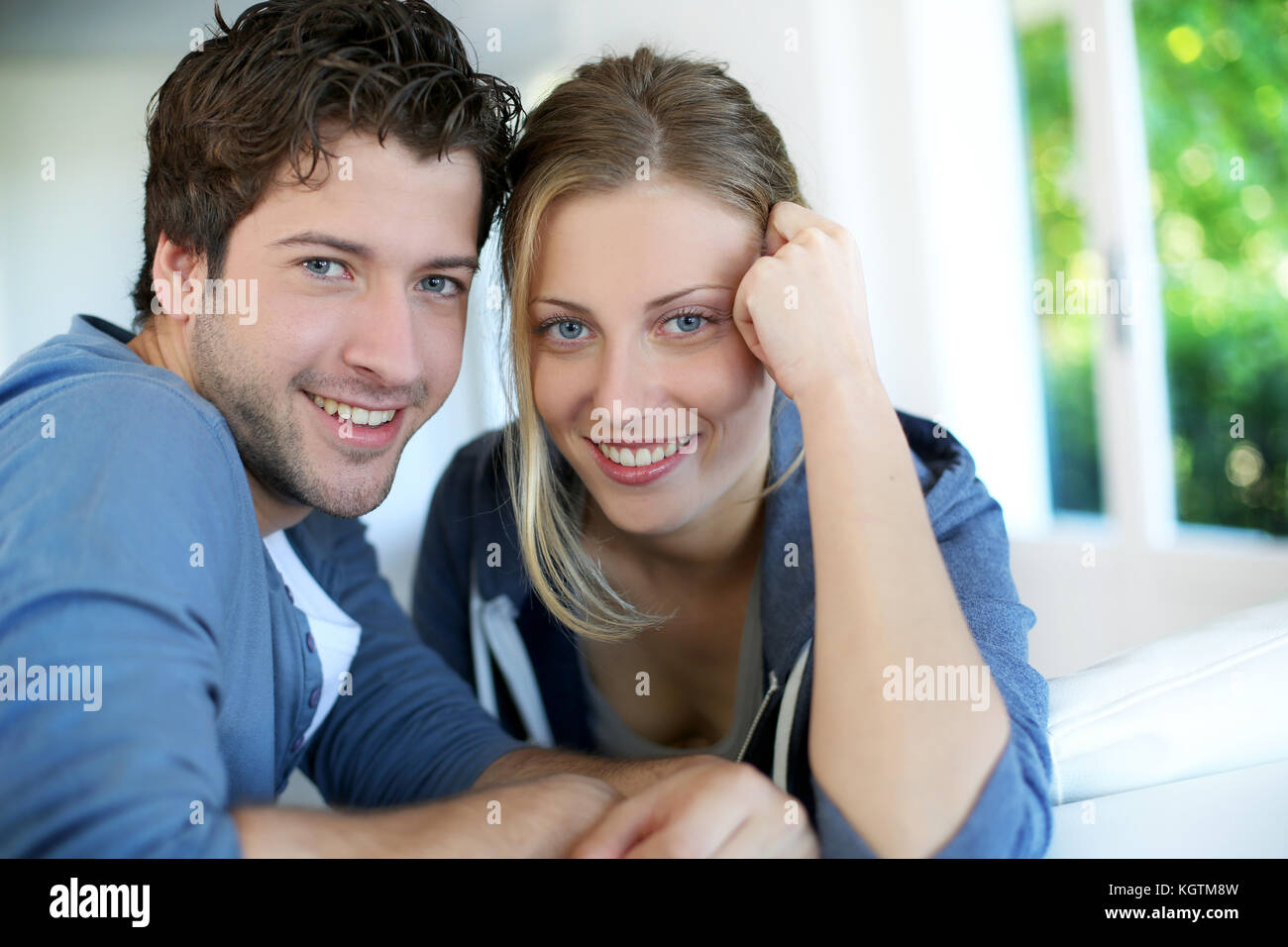 Closeup of cheerful young couple wearing blue Stock Photo - Alamy
