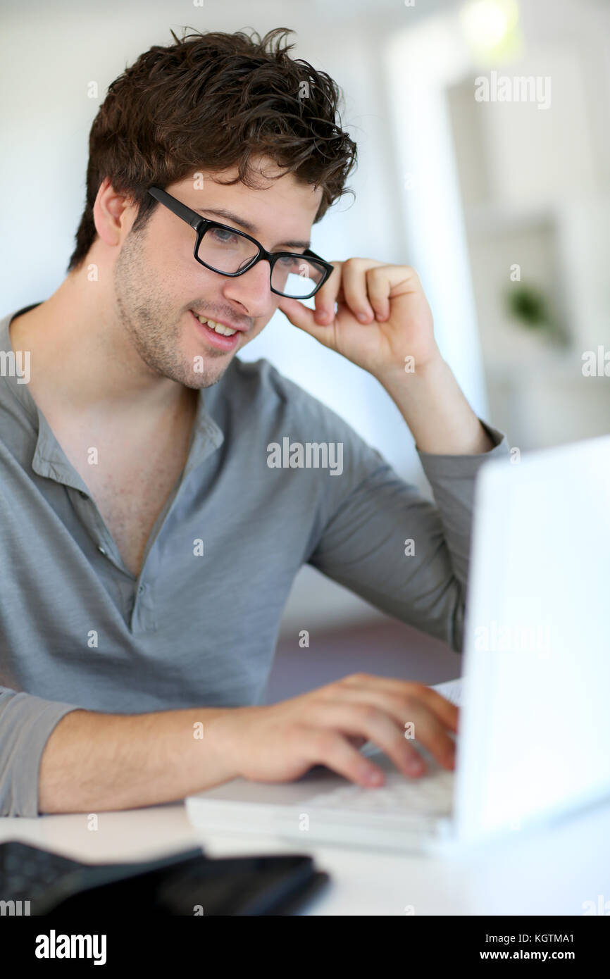 Young man studying from home Stock Photo - Alamy