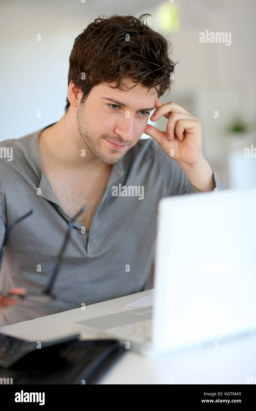 Young man studying from home Stock Photo - Alamy