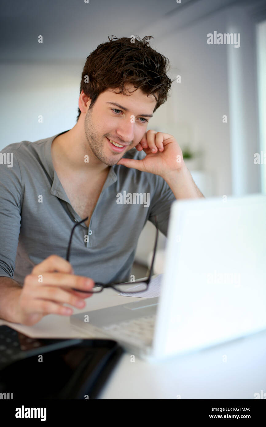 Young man studying from home Stock Photo - Alamy
