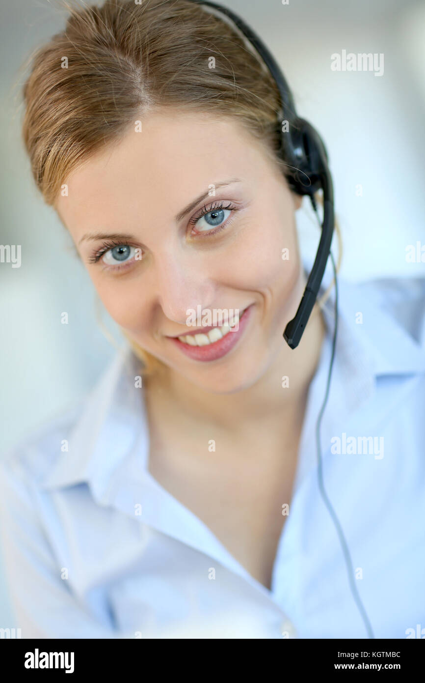 Closeup of attractive blond customer service assistant Stock Photo - Alamy